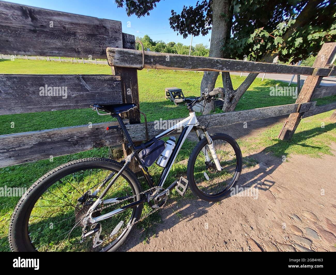 Bicycle leaning on fence hi-res stock photography and images - Alamy