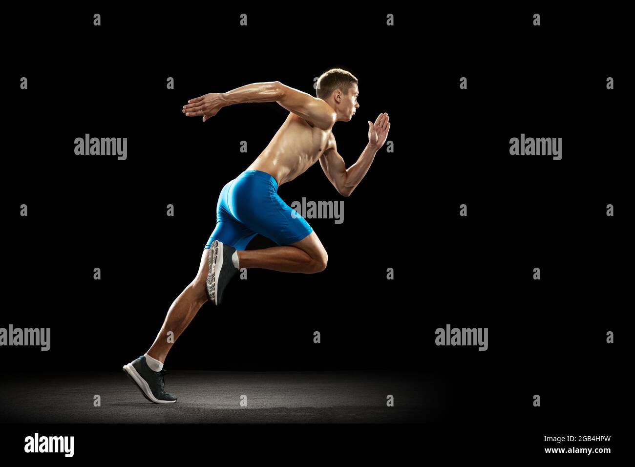One Caucasian professional male athlete, runner training isolated on ...