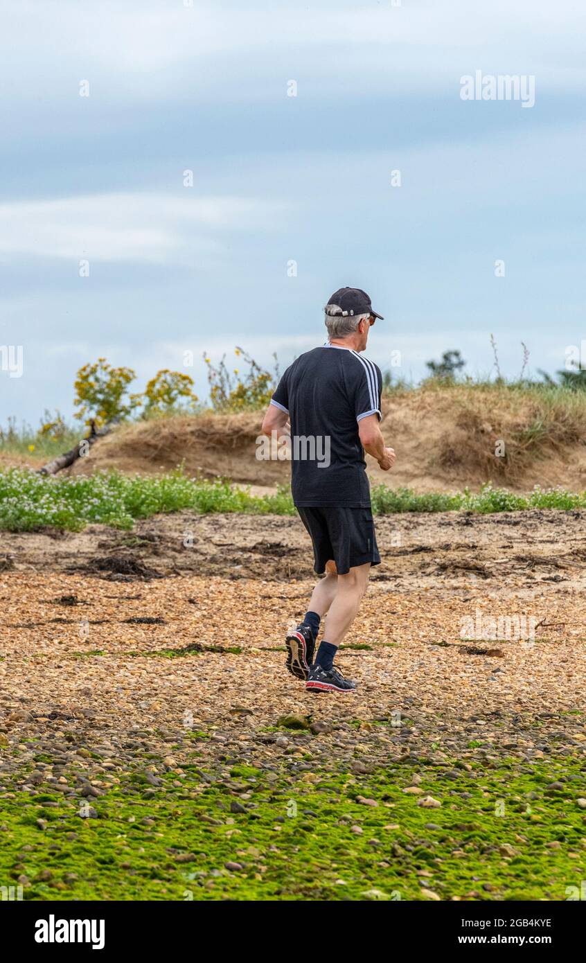 older ageing man running or jogging to keep fit in retirement Stock ...