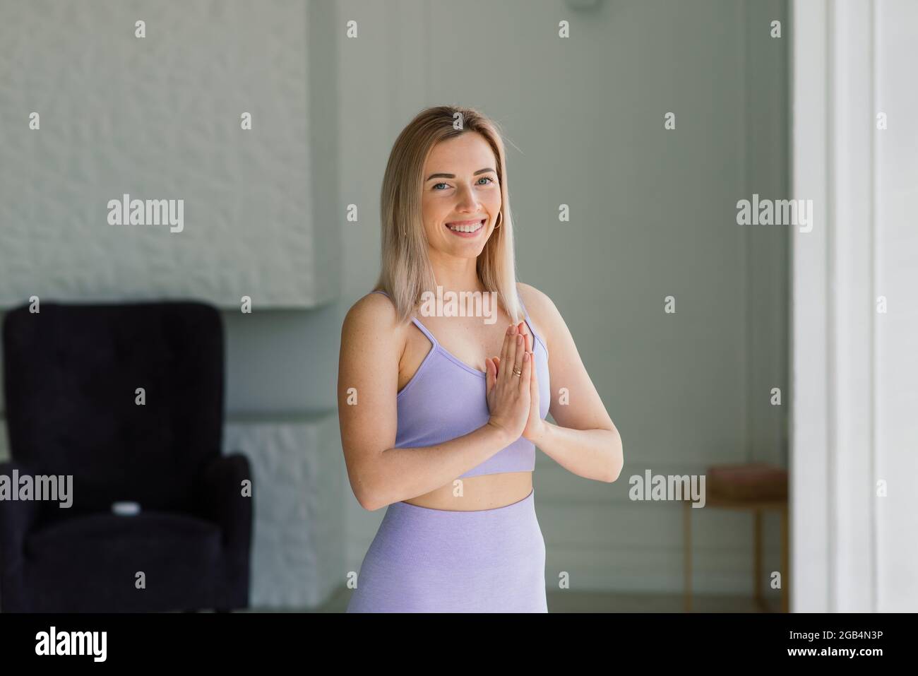 Young woman meditating, doing yoga at home, back, front and side view ...