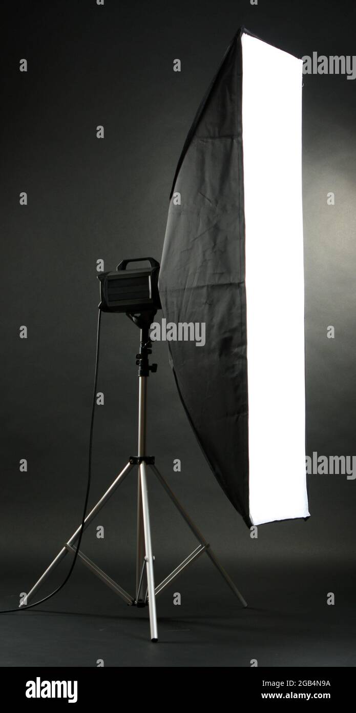 Studio flash with soft-box on black studio background Stock Photo - Alamy
