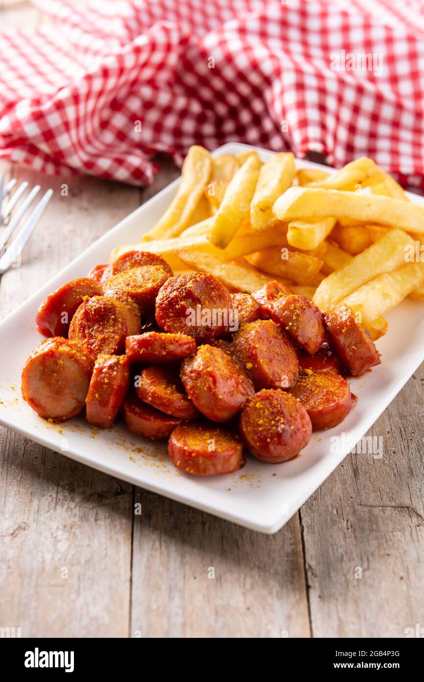 traditional German currywurst on wooden table Stock Photo - Alamy