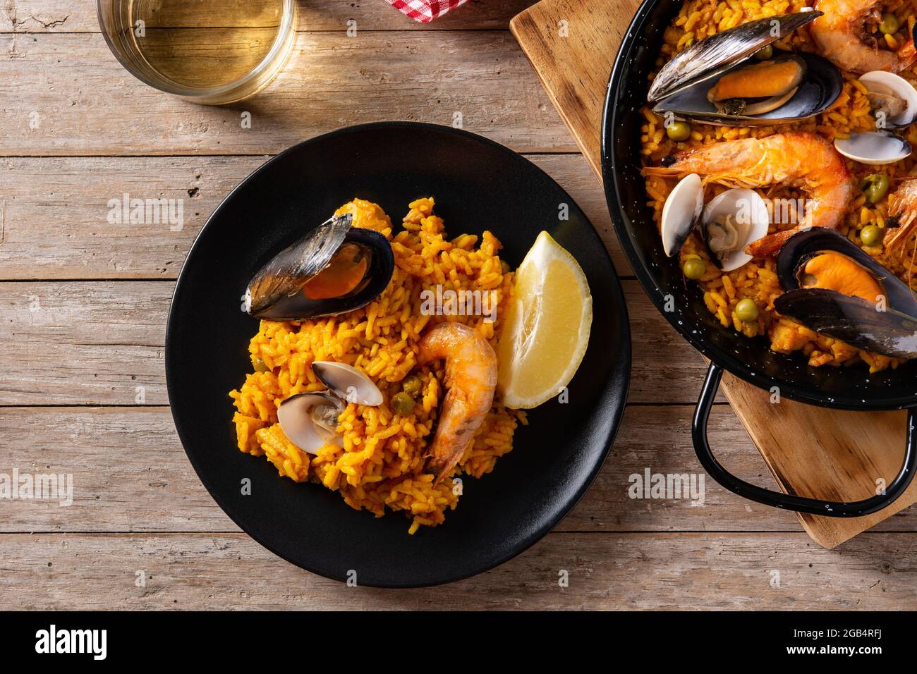 Traditional spanish seafood paella on wooden table Stock Photo - Alamy