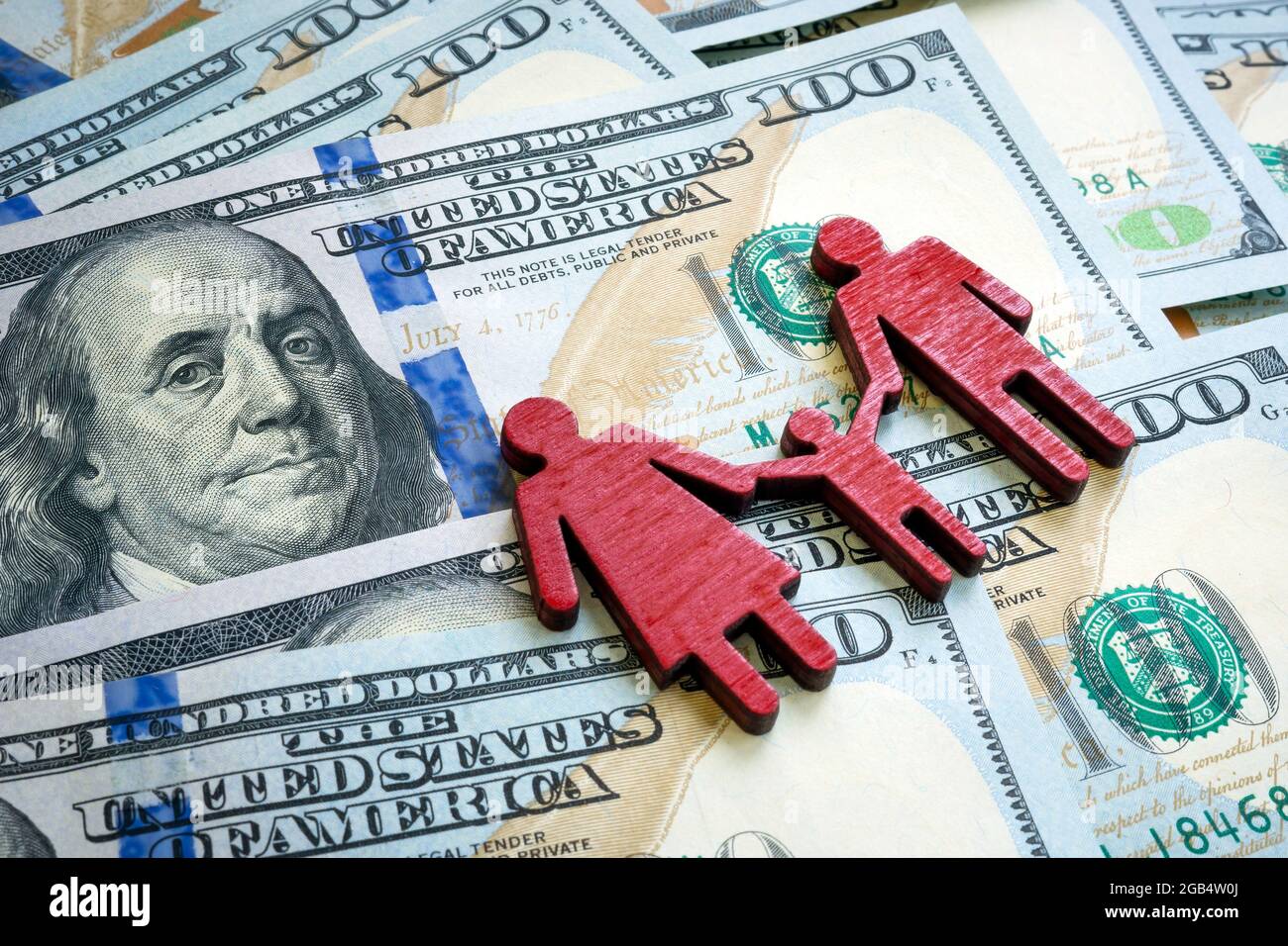 Figures of family and money. Child tax credit concept Stock Photo - Alamy