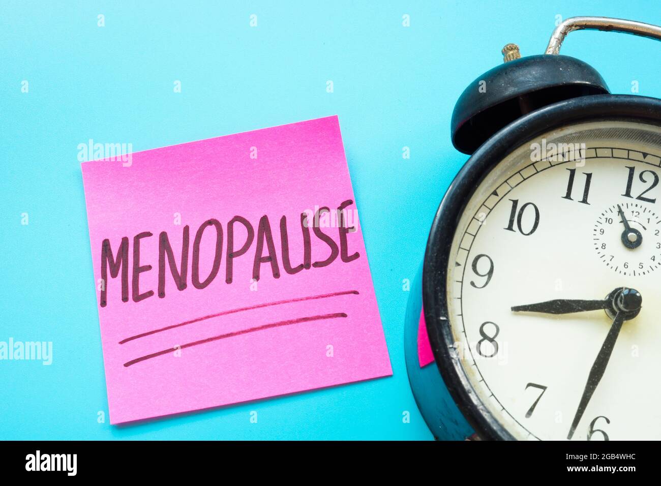 Menopause word handwritten on the sticker and alarm clock Stock Photo ...