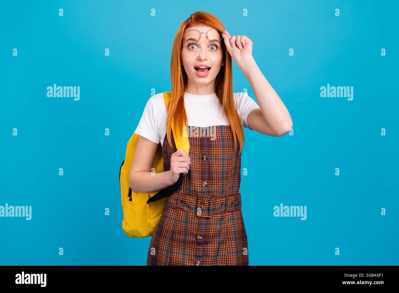 Portrait of attractive amazed cheerful nerd girl touching specs wow new ...