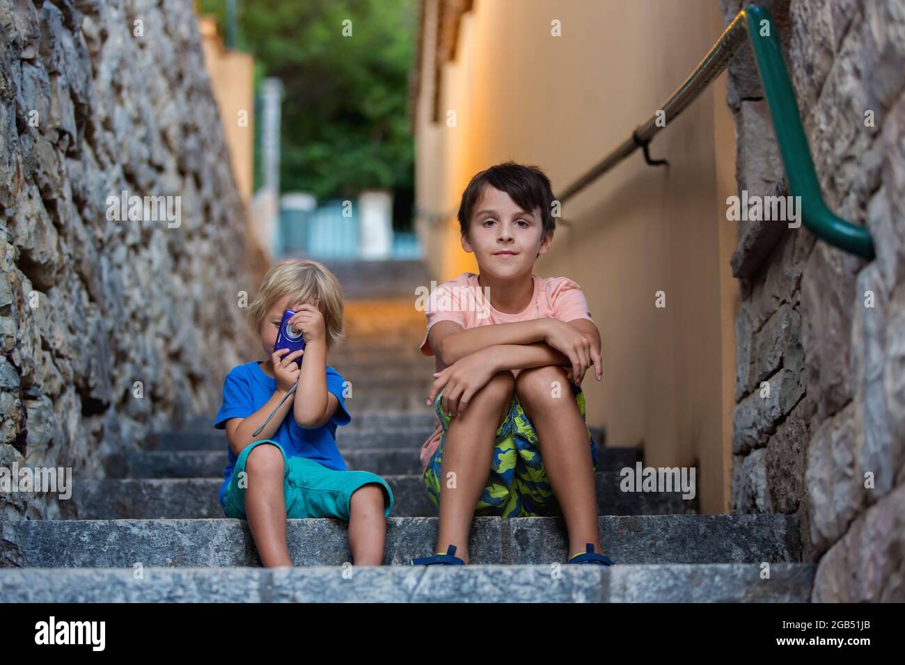 Happy beautiful children, boys, playing on stone staircasechild, kid ...