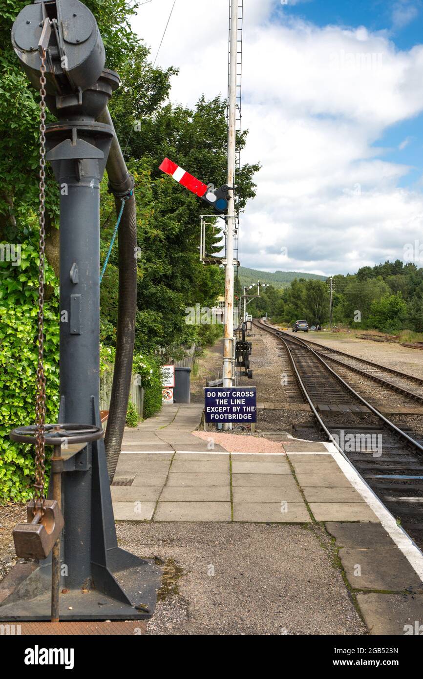 steam railway. Railway station water tank and train filling hose bowser ...