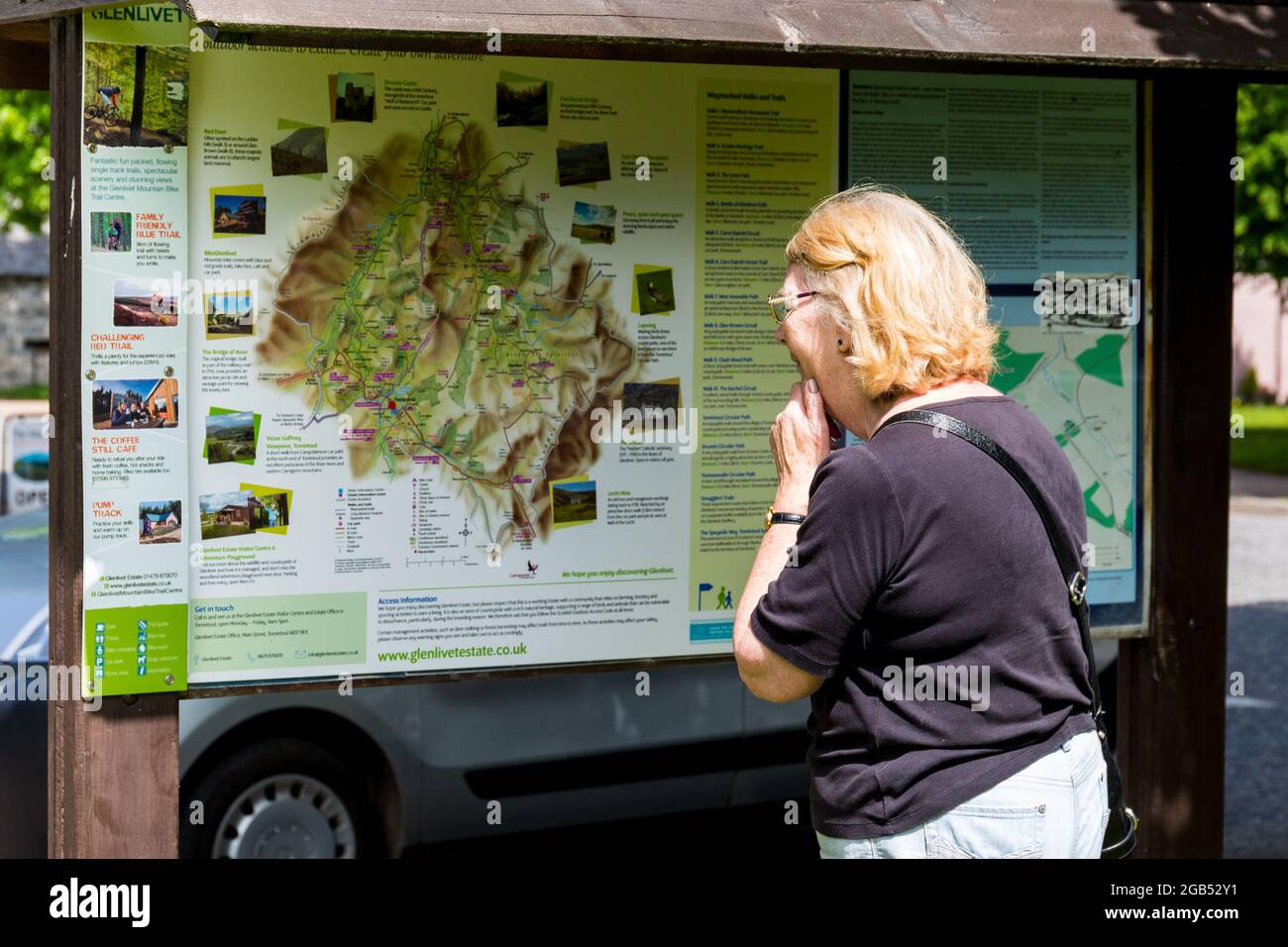 Tourist studying local area map. Tomintoul. Scottish Highlands Scotland ...