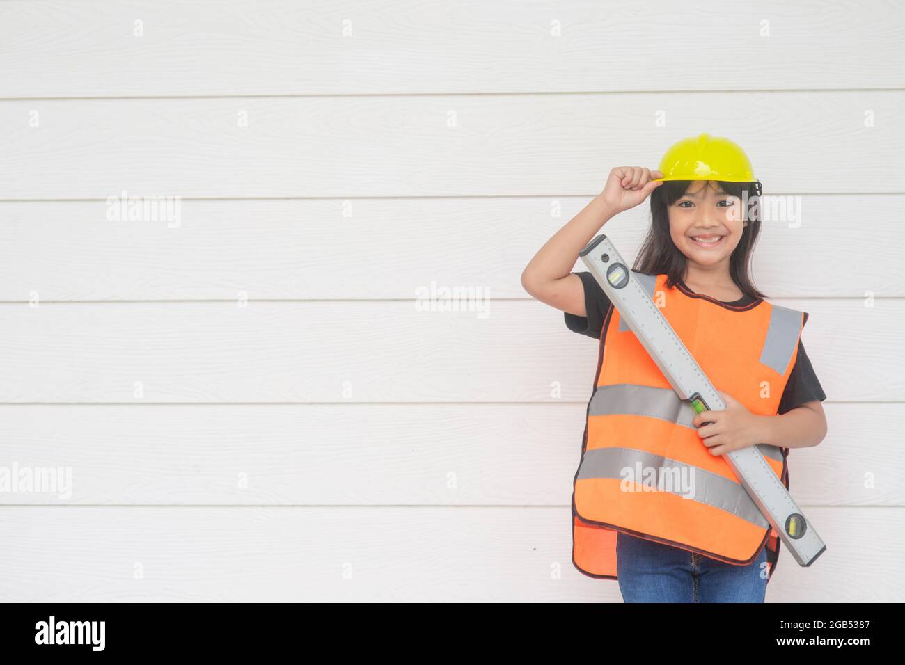 Asian girls pretending to be a construction worker Stock Photo - Alamy