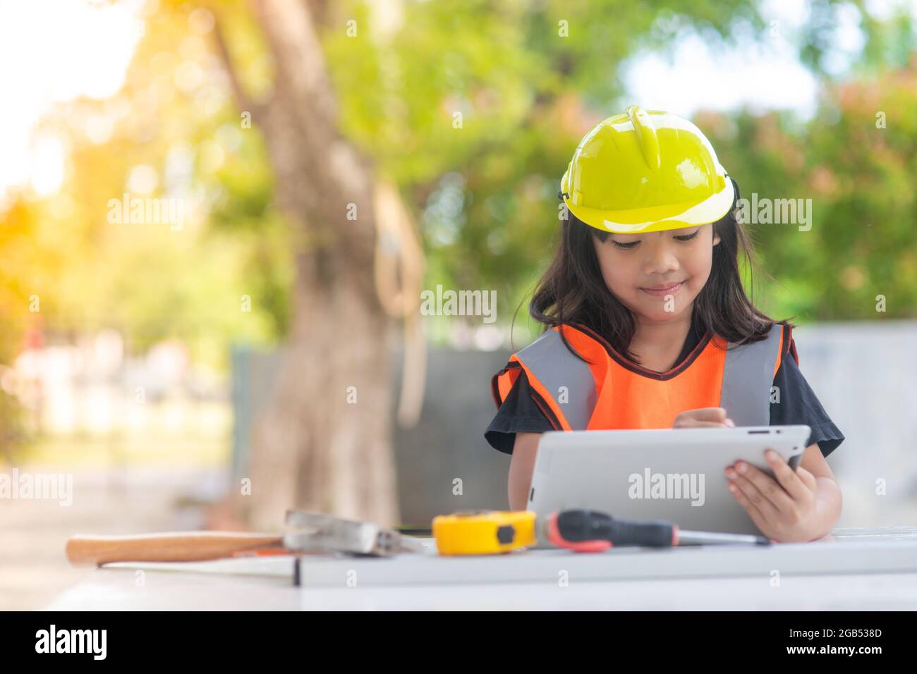 Asian girl children playing as an engineer helmet are smiling and happy ...
