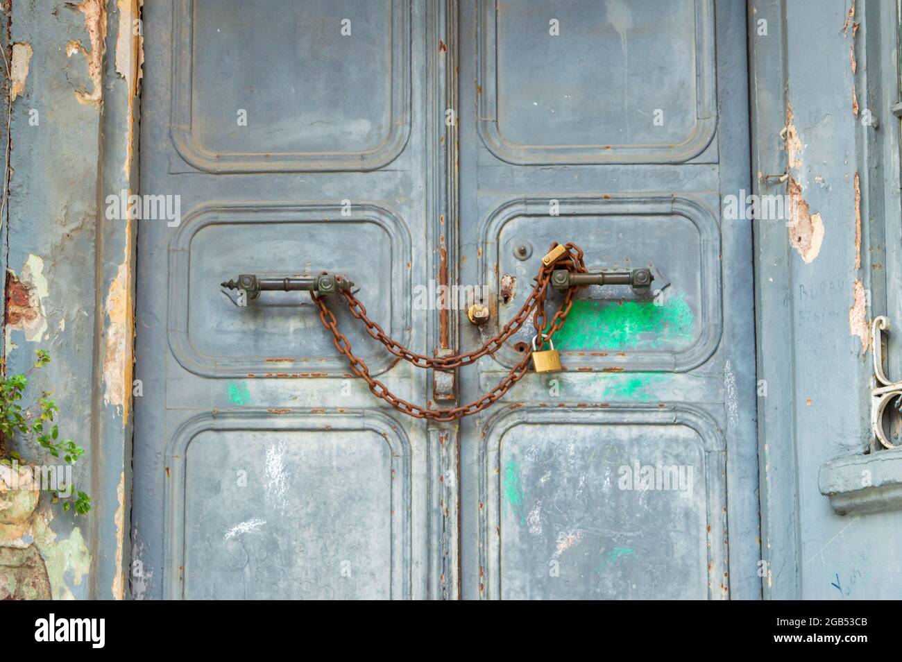 An old door that was chained and locked. an inaccessible old building ...