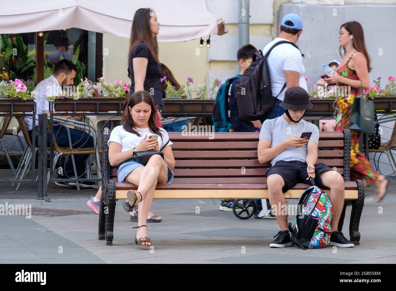Moscow. Russia. August 1, 2021. Young man and woman are sitting on a ...