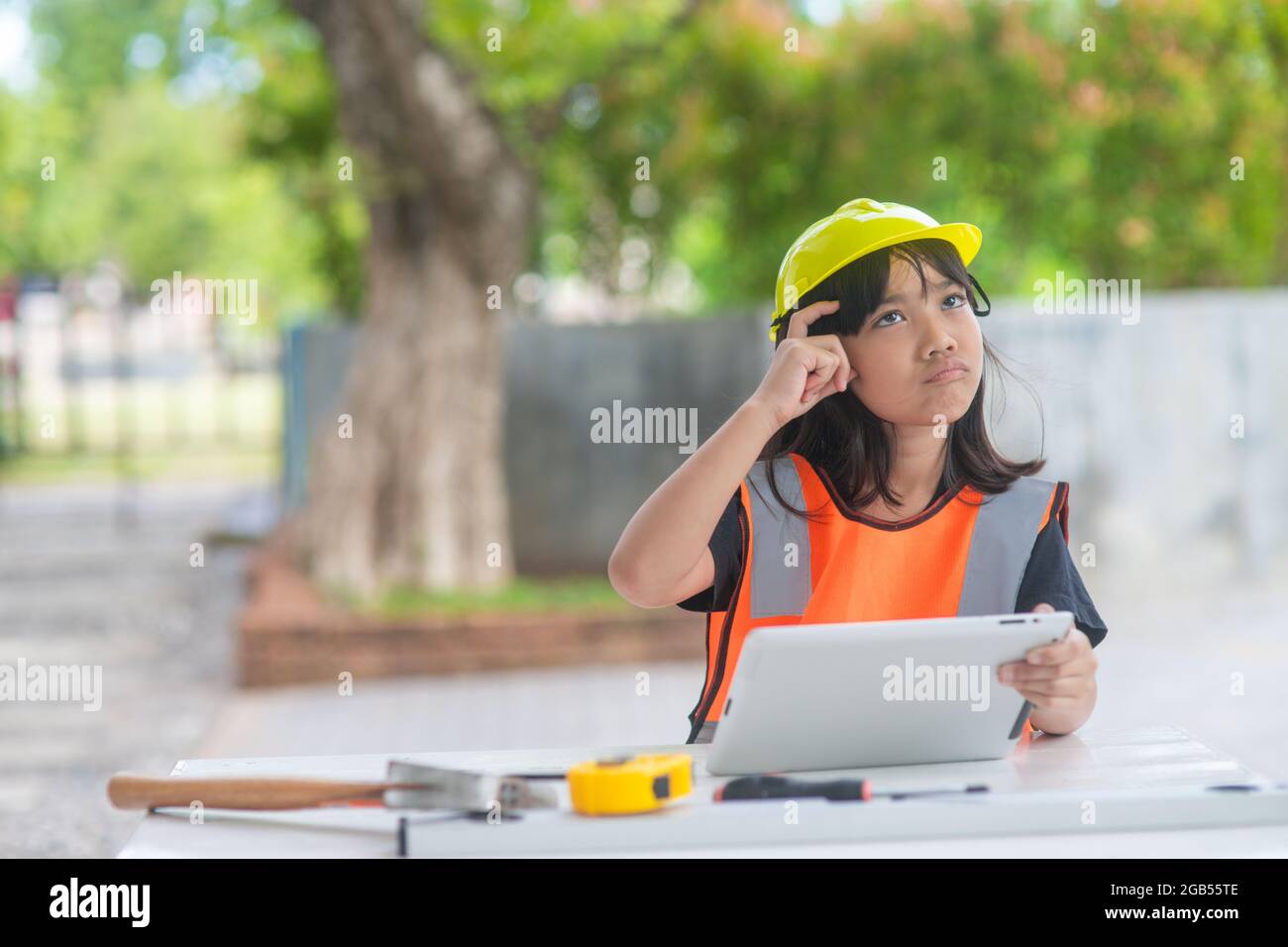 Asian girl children playing as an engineer helmet are smiling and happy ...