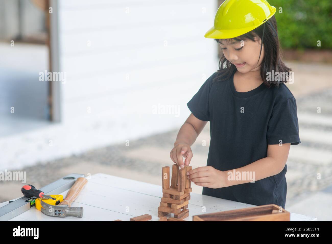Asian girl children playing as an engineer helmet are smiling and happy ...