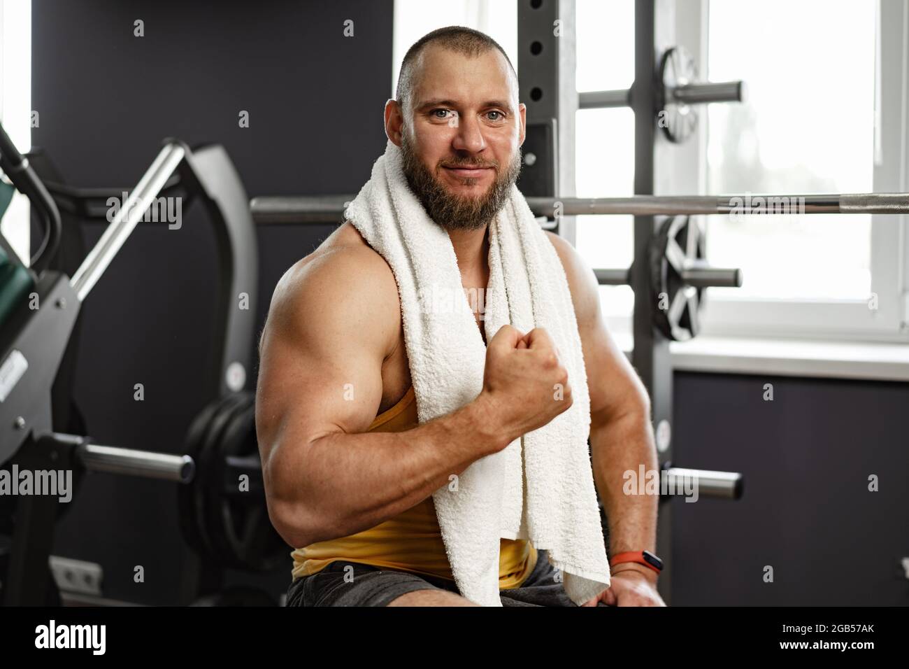 Cheerful smiling man bodybuilder standing in a gym Stock Photo - Alamy