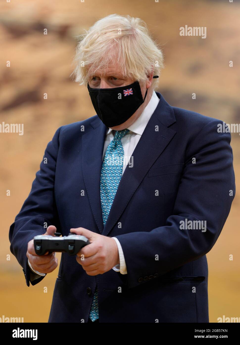 Prime Minister Boris Johnson uses a control box to move one of the ...