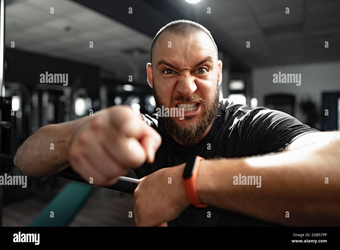 Cheerful smiling man bodybuilder standing in a gym Stock Photo - Alamy