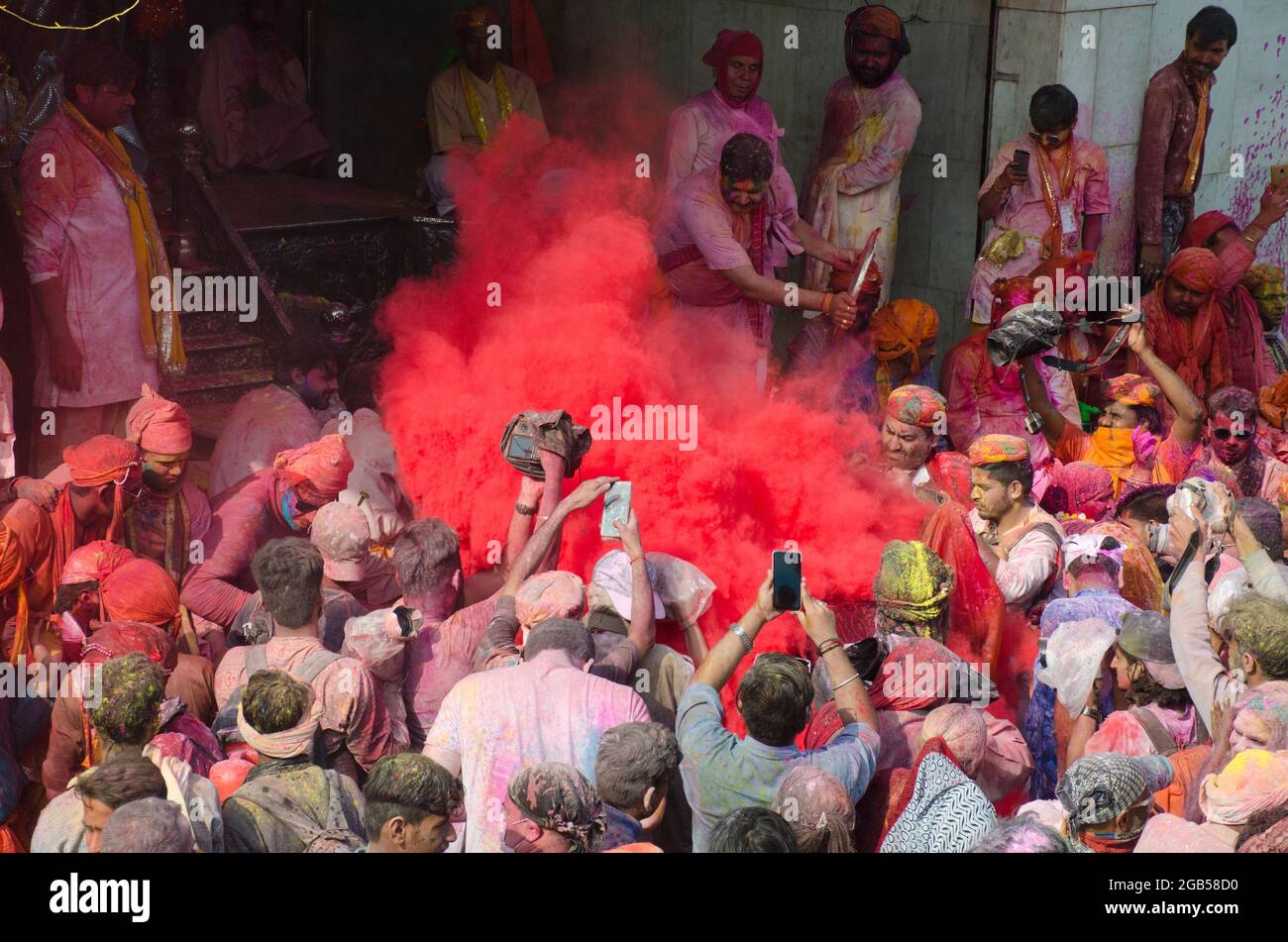 Priests and pilgrims are throwing colors to each showing the joyousness ...