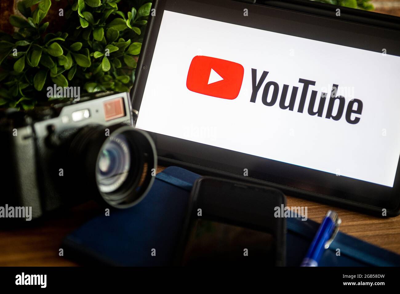 In this photo illustration a YouTube logo seen displayed on a tablet ...