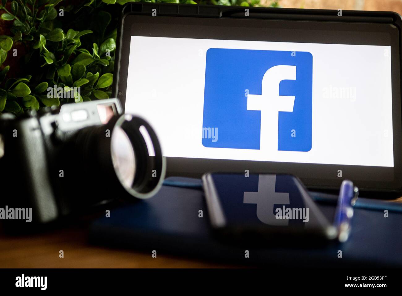 In this photo illustration, a Facebook logo seen displayed on a tablet ...