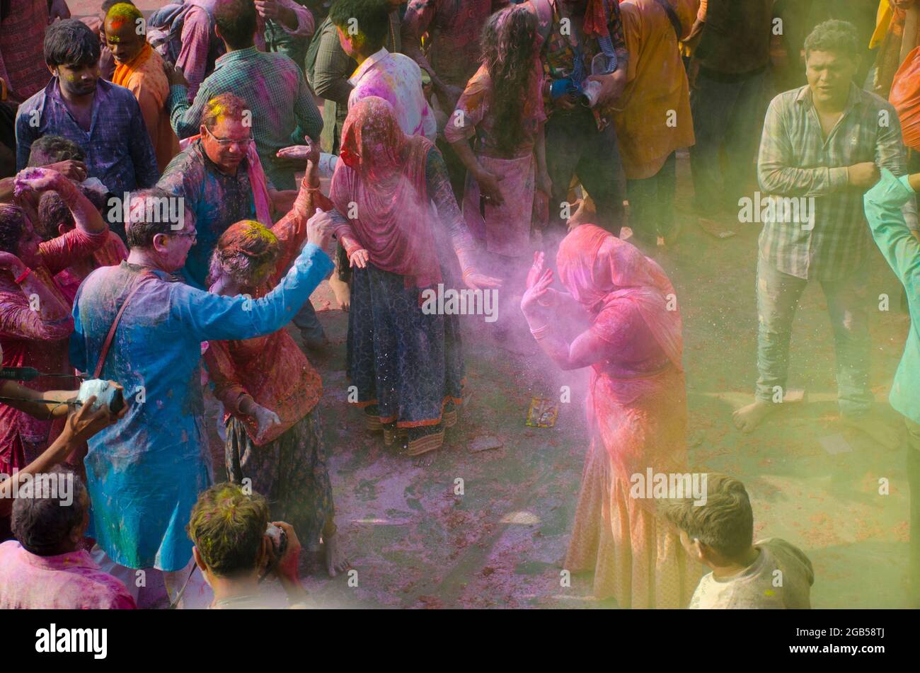 Ladies are spinning while dancing in joy, celebrating the Holi festival ...