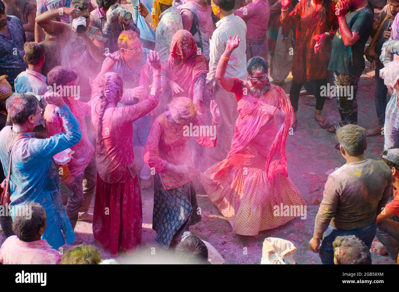 Ladies are spinning while dancing in joy, celebrating the Holi festival ...