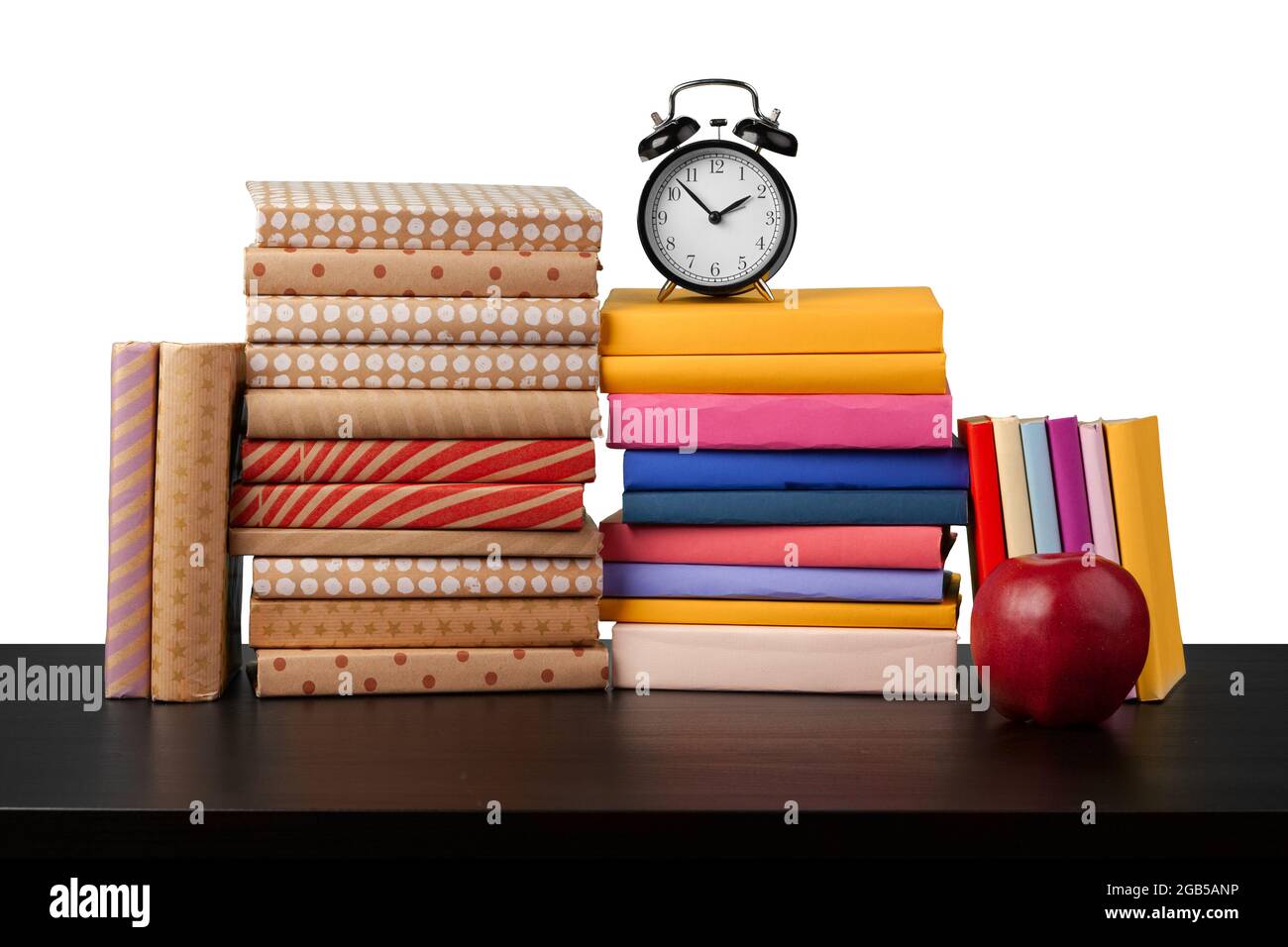 Stack of books and apple on tabletop against white background Stock ...