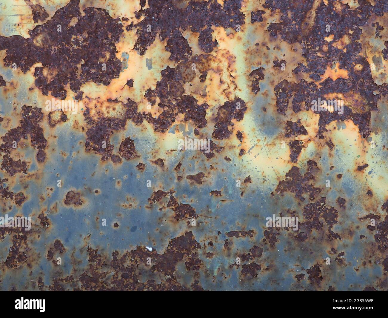 Heavily ruined metal surface textured with big rust spots background ...