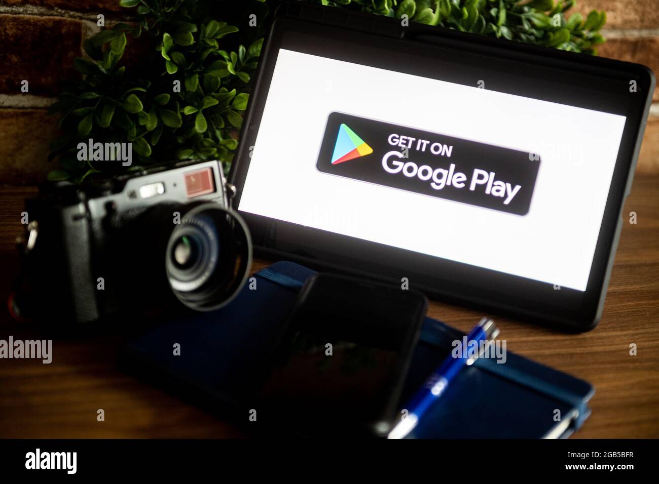 In this photo illustration a Google Play logo seen displayed on a tablet. (Photo by Mateusz ...