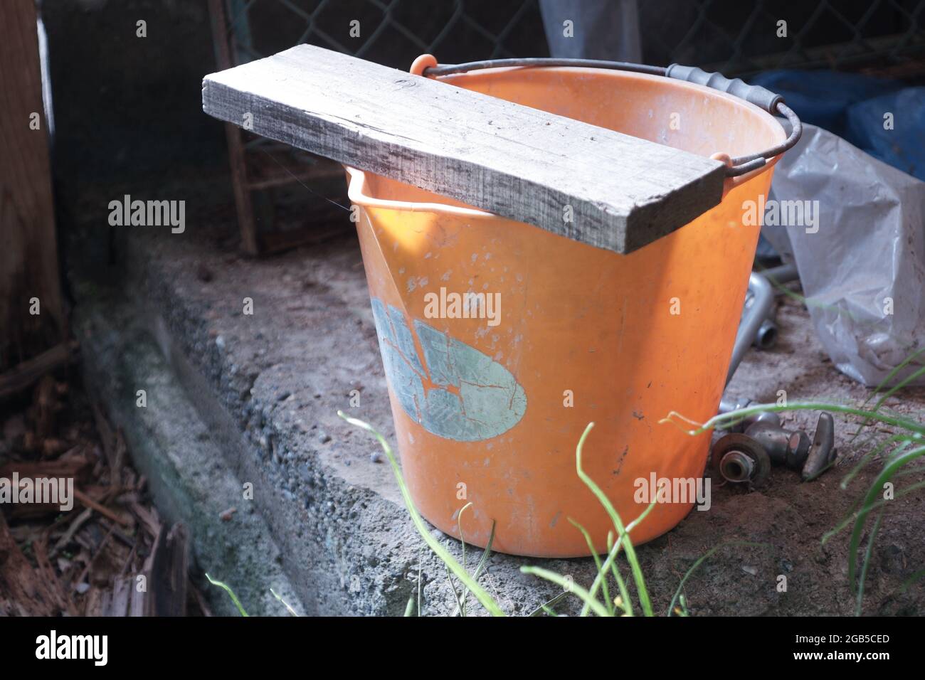Old Plastic Bucket on the Concrete Floor Stock Photo - Alamy