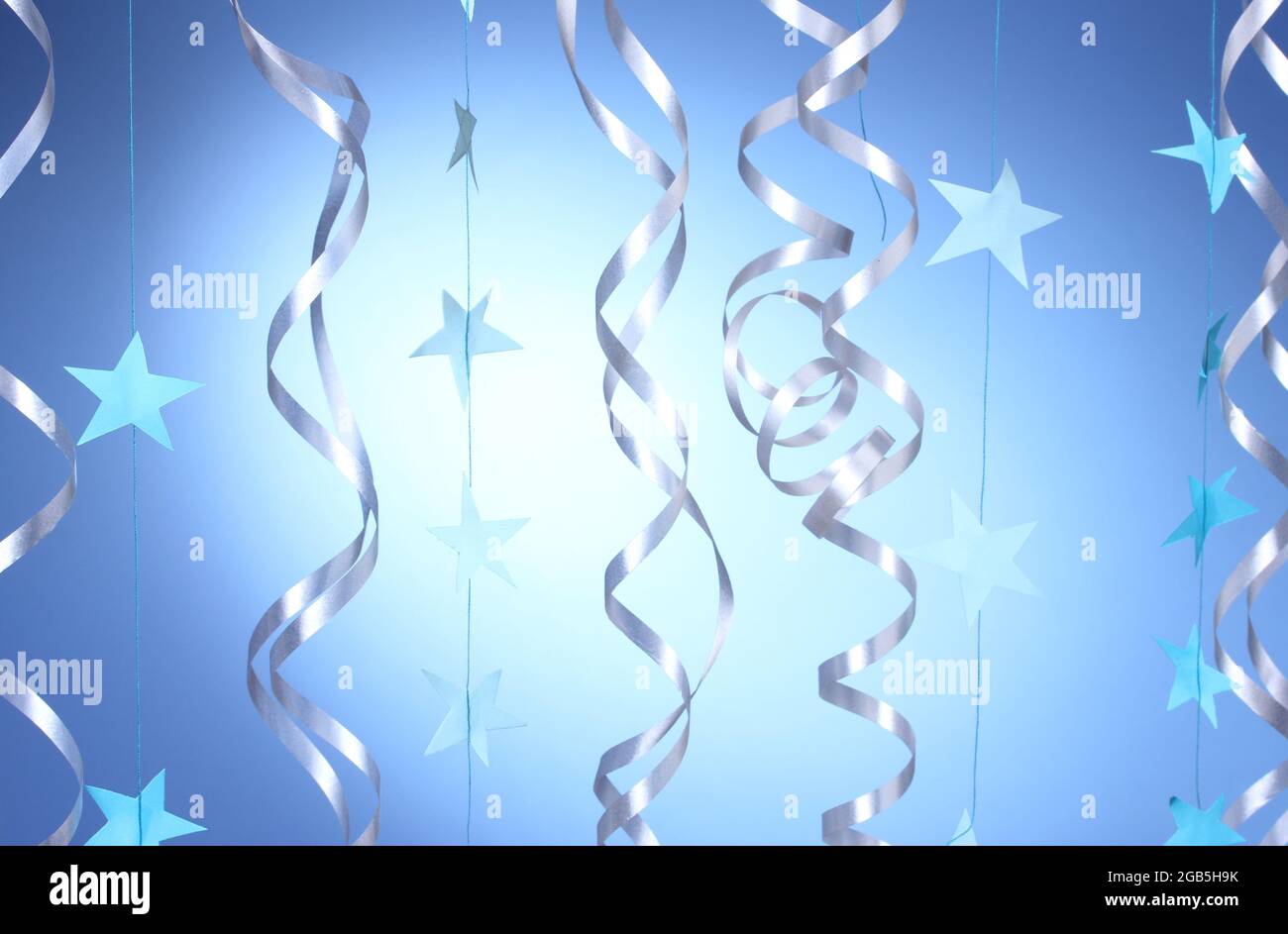 beautiful streamers and stars on blue background Stock Photo - Alamy