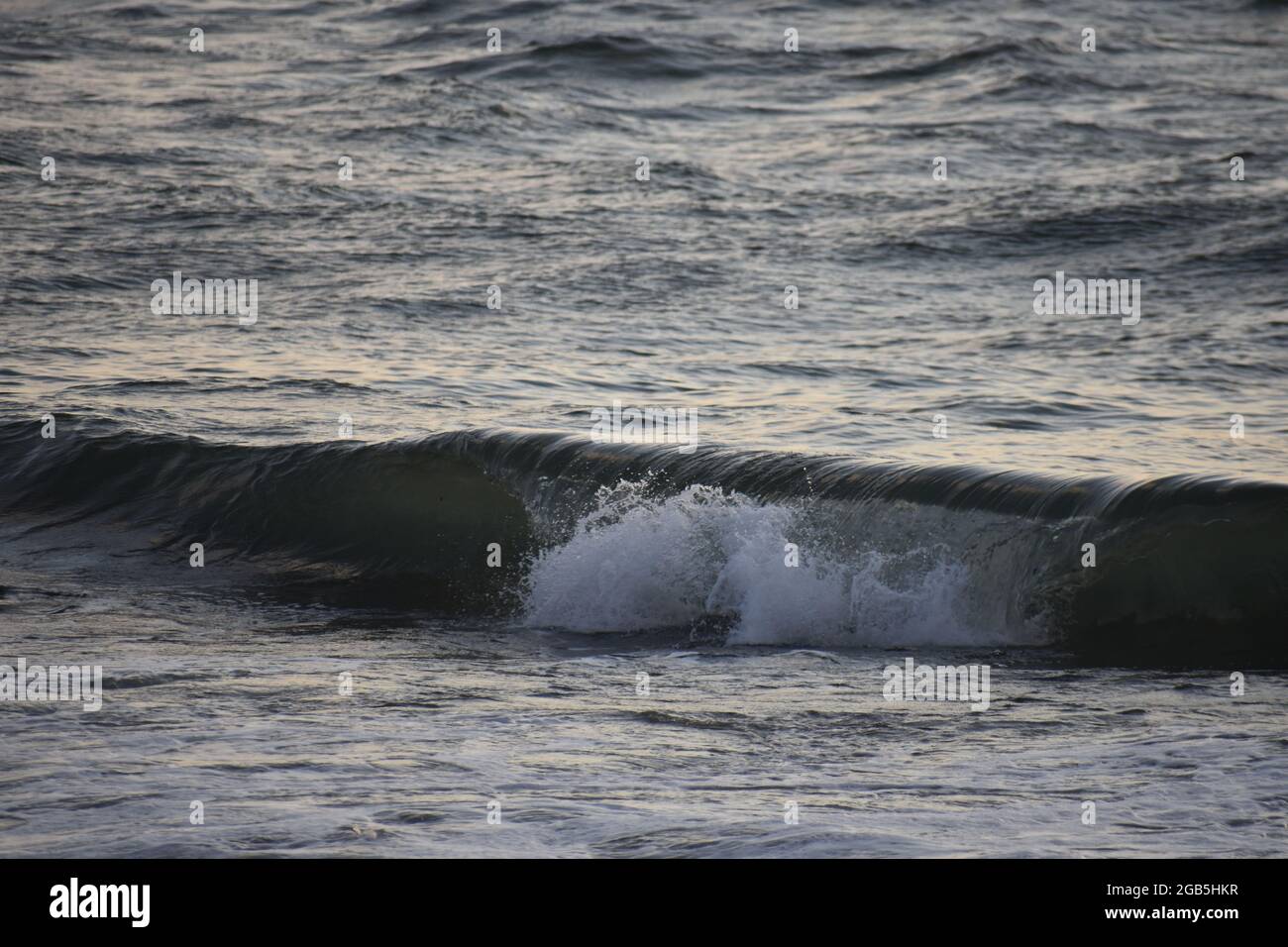 Wave breaking into calm water hi-res stock photography and images - Alamy