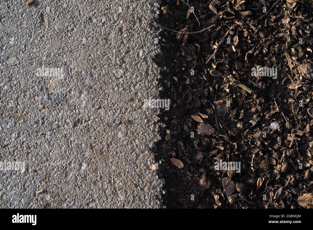 Top view of a ground and asphalt showing the separation of road and ...