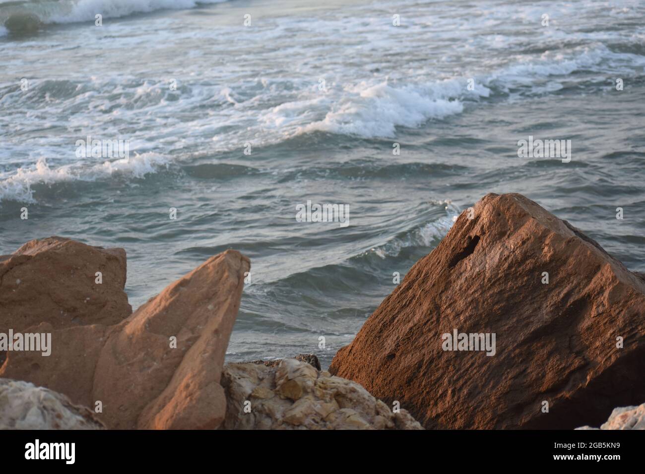 Angular Rocks in front of Breaking Waves in the Mediterranean Sea Stock ...