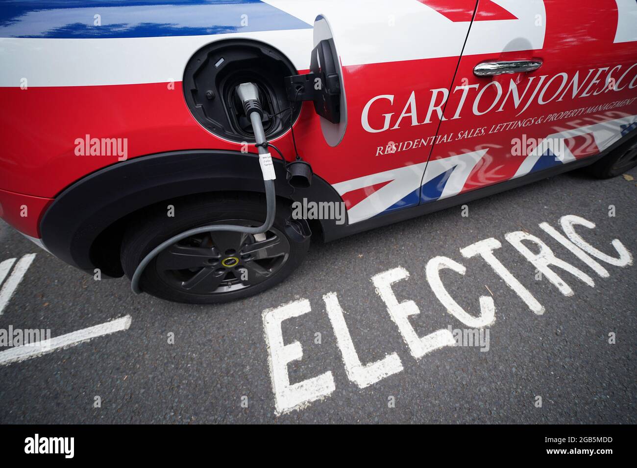 A MINI Electric car is plugged into a public Pod Point charging point ...