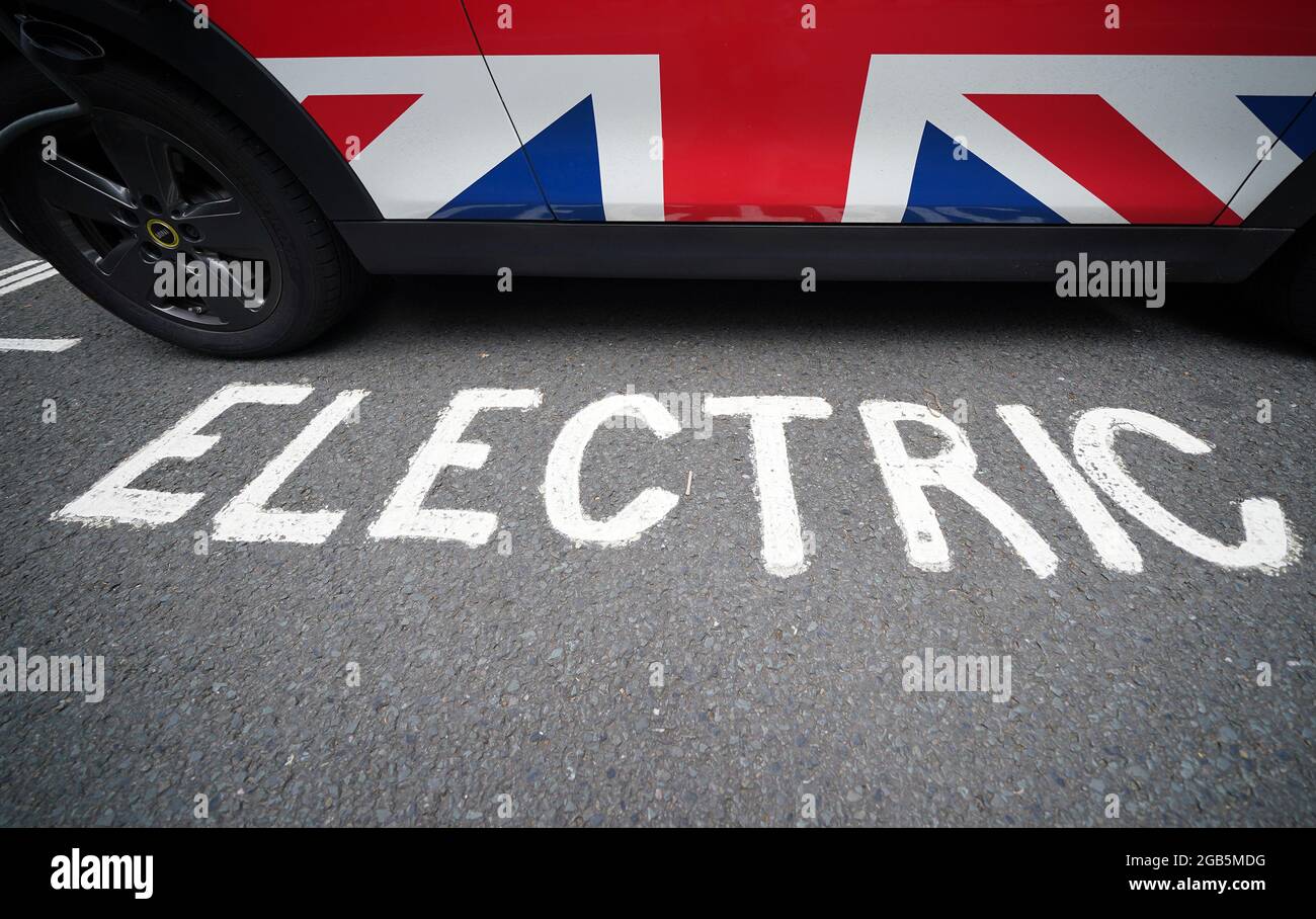 A MINI Electric car is plugged into a public Pod Point charging point ...