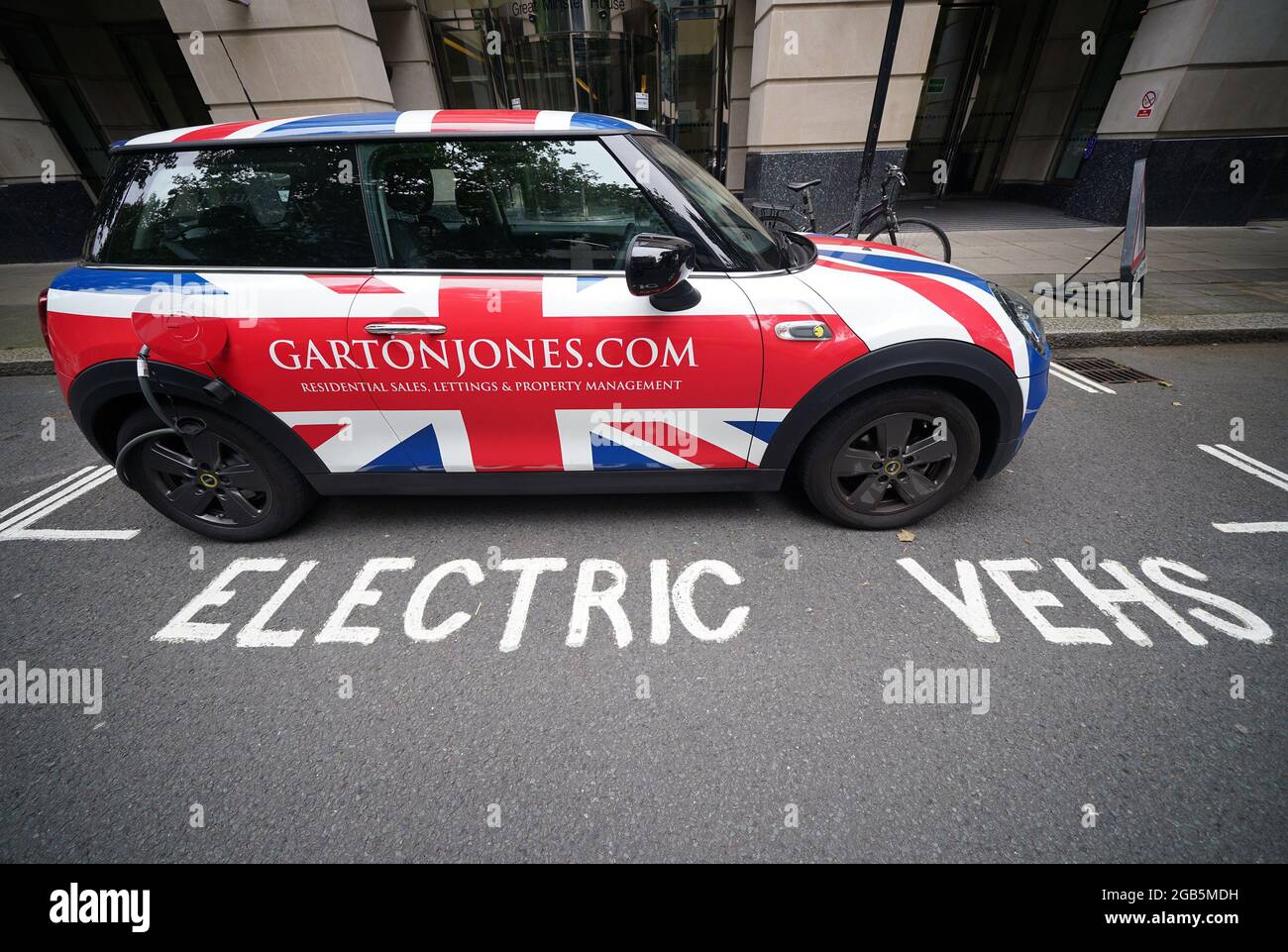 A MINI Electric car is plugged into a public Pod Point charging point ...