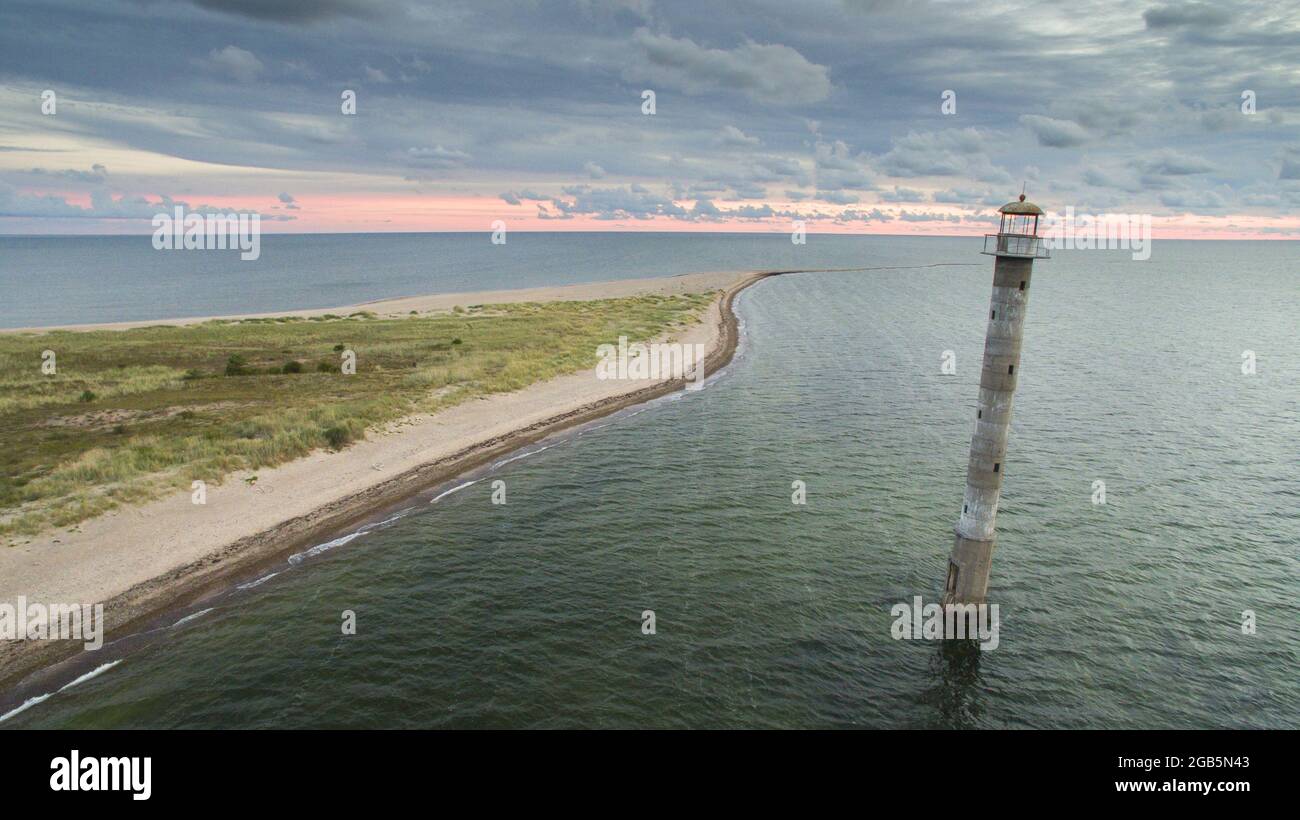 Aerial shot of a small lighthouse on the ocean and the coastline Stock ...