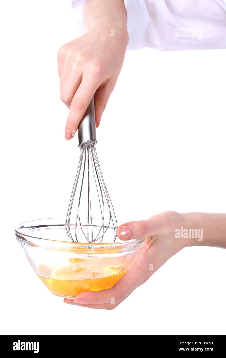 Female hands Mixing eggs in bowl isolated on white Stock Photo - Alamy