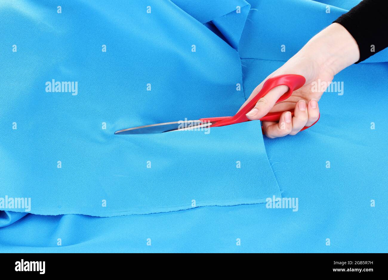 Woman cutting fabric Stock Photo - Alamy
