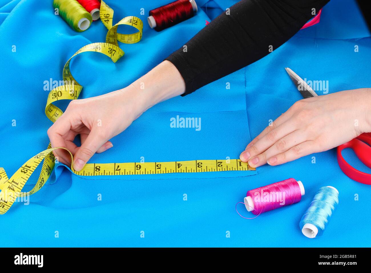 Woman cutting fabric Stock Photo - Alamy