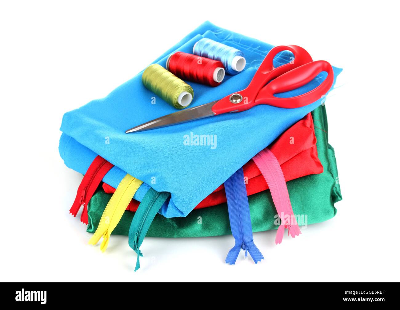 Scissors, bright thread and zips on fabric isolated on white Stock ...