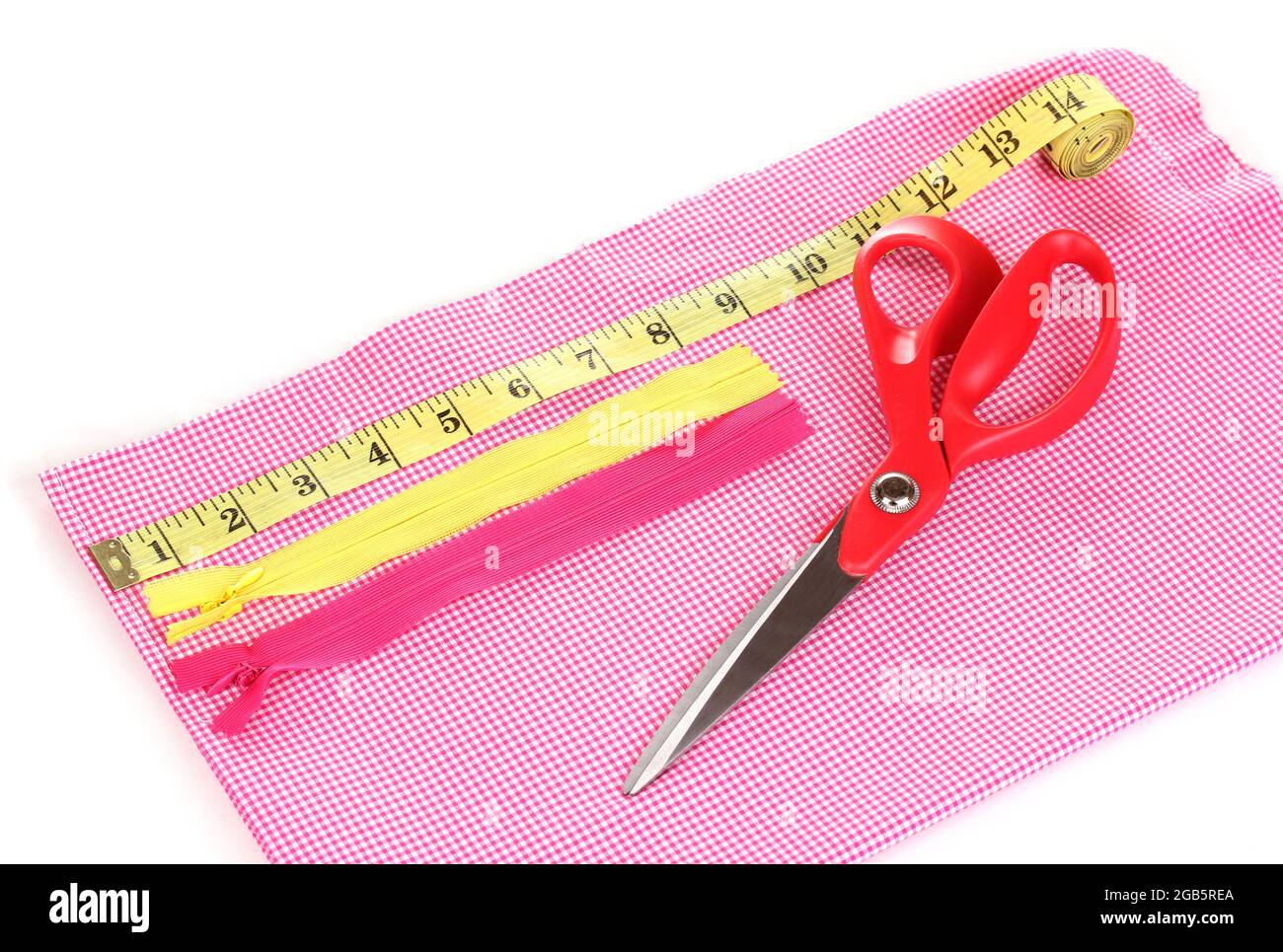 Scissors and measuring tape on fabric isolated on white Stock Photo - Alamy