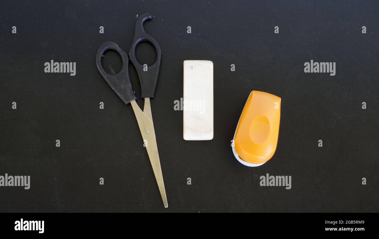 Scissors, Eraser, and a Stapler on a Black Background Stock Photo - Alamy