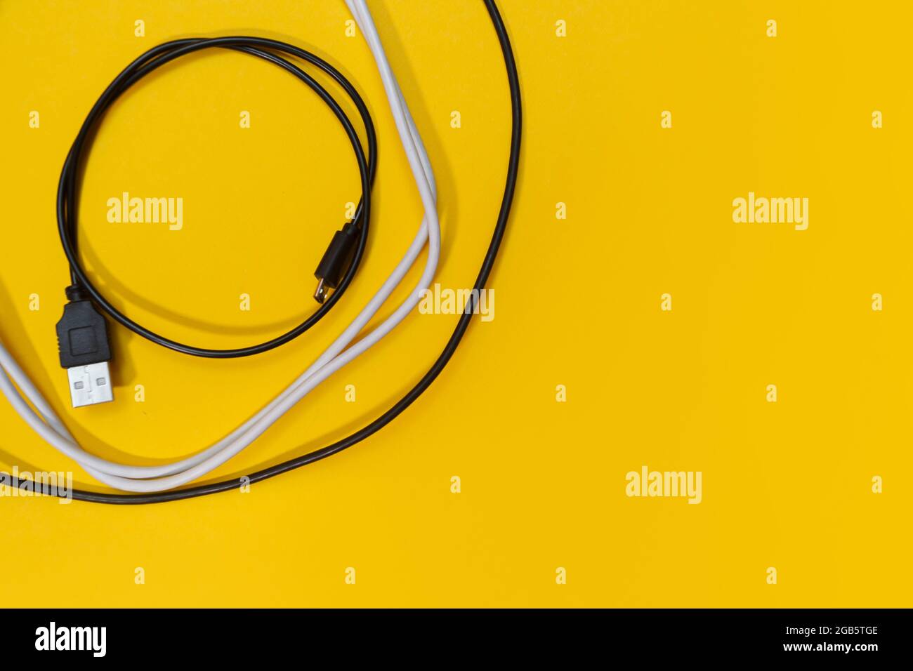 USB wires on a yellow background Stock Photo - Alamy