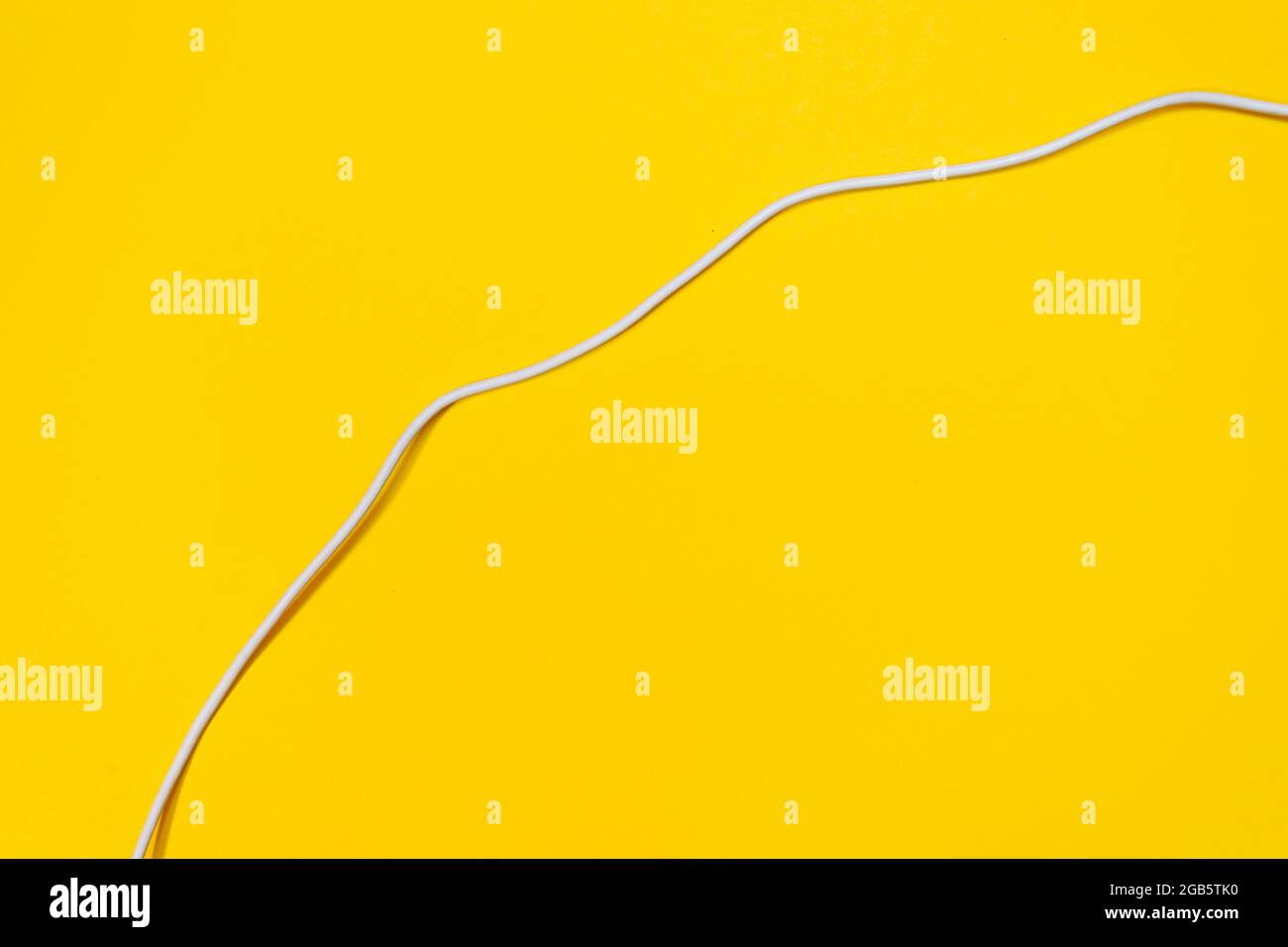 USB wires on a yellow background Stock Photo - Alamy