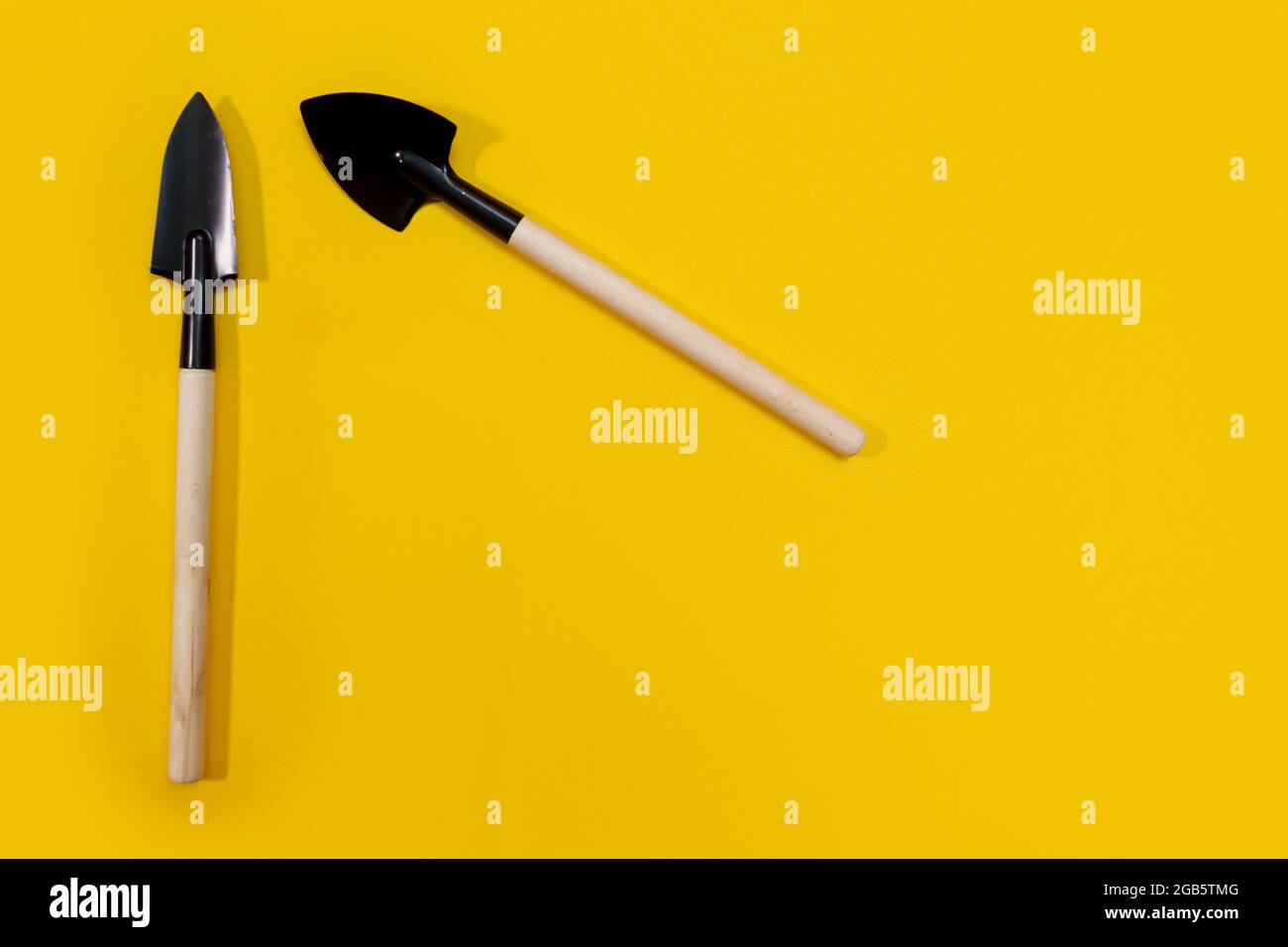 Gardening tools on yellow background Stock Photo - Alamy