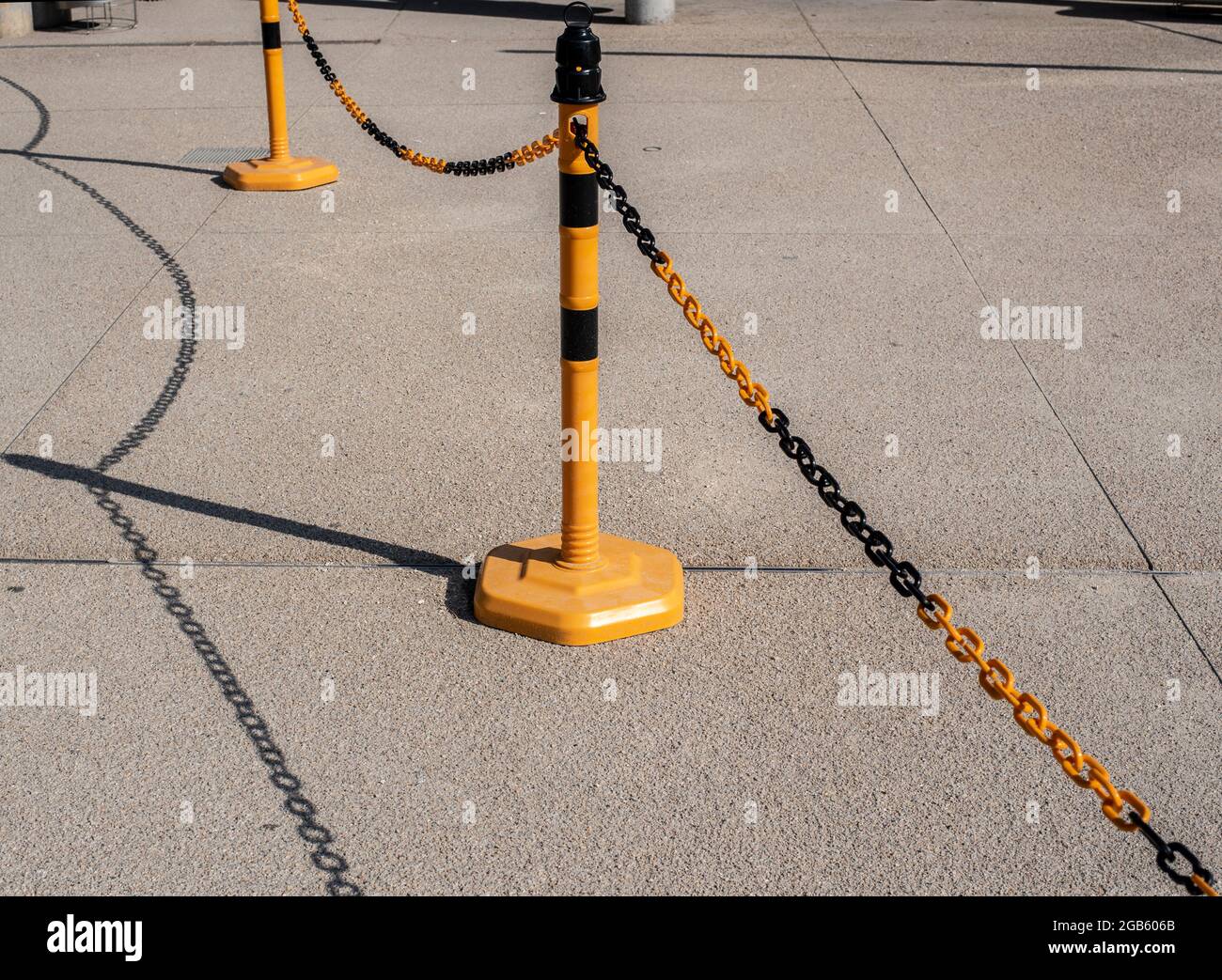 a safety boundary consisting of a plastic post and chain Stock Photo ...