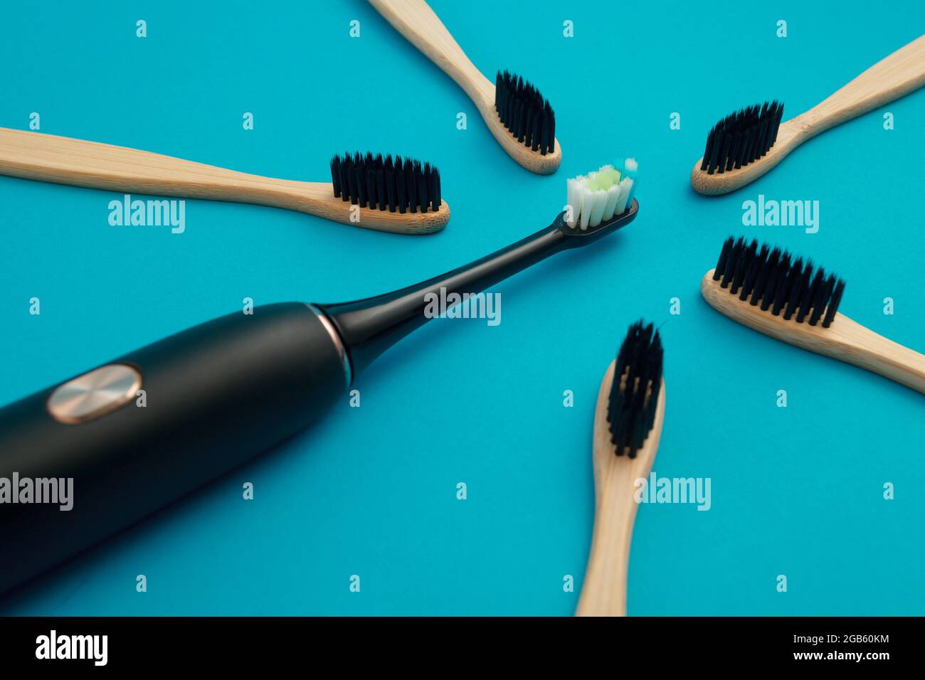 Electric and wooden toothbrush on blue background Stock Photo - Alamy